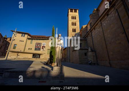 Sculpture of Abbot Oliba in front of the Romanesque bell tower of the ...