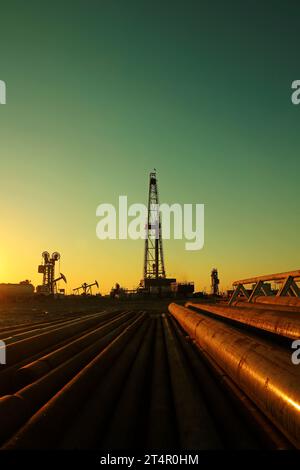 In the evening of oilfield derrick Stock Photo - Alamy