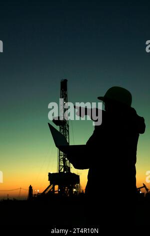 Oil drilling frame and exploration technician in a oilfield Stock Photo ...