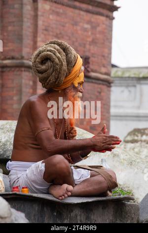 Kathmandu, Nepal: legs crossed hindu guru waiting for a family to ...