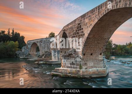 The historical Aspendos Bridge over Koprucay at sunrise in Antalya ...