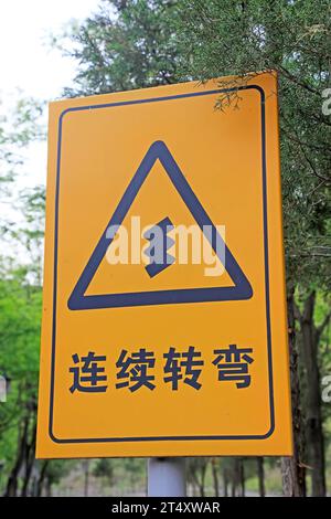 Continuous turning warning sign Stock Photo - Alamy
