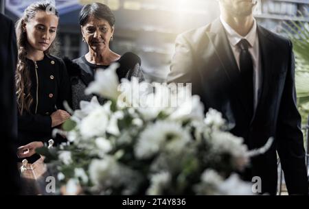 Death, funeral and family touching coffin in a church, sad and unhappy ...