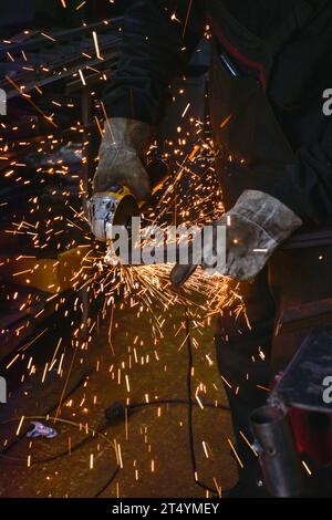 Master grind metal a grinder sparks Stock Photo - Alamy
