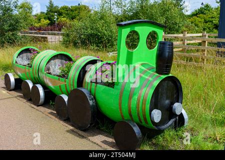 Decorative flower planter made from barrels in the style of a railway ...
