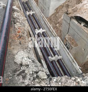 Pipes in the ground under asphalt Stock Photo - Alamy
