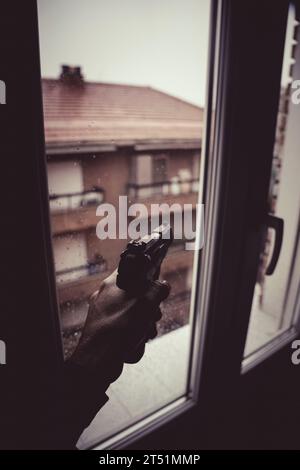 Gunman holding pistole in window dramatic photo book cover design Stock ...