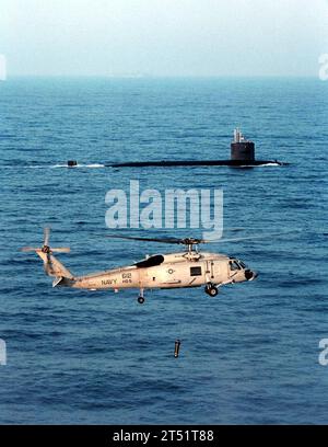 A Sturgeon class nuclear-powered attack submarine, the large harbor tug ...
