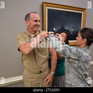 The Chief of Naval Operations (CNO) receives a challenge coin as a ...