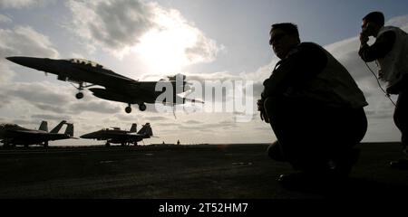 A landing signal officer (LSO) watches as an F-4S Phantom II aircraft ...