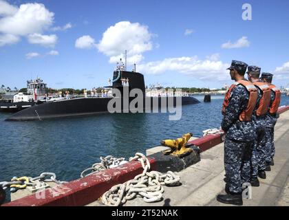 Line handlers stand by on the pier as the tank landing ship USS ...