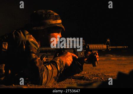 A US Navy SEAL (Third from front), from SEAL Team 8, shoots a Colt 5.5 ...