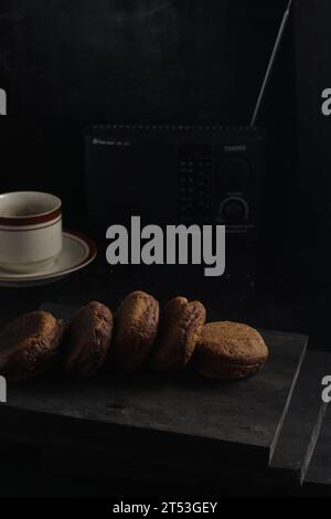 Apang bale cake or Apang bakar, and a cup of tea isolated on black ...