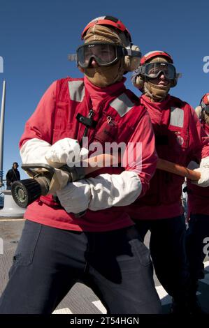 US Navy Damage Control Crash and Salvage team members don proximity ...