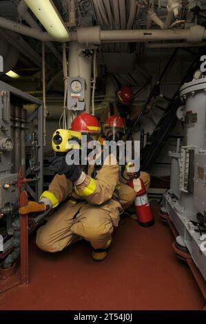 US Navy Fire assessment members use a naval firefighting thermal imager ...