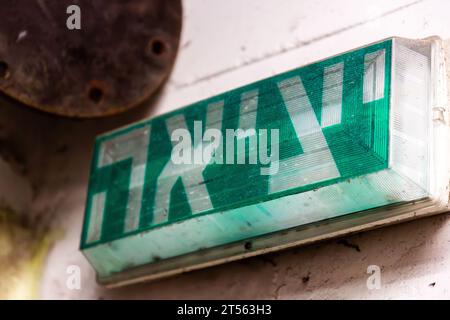 Exit sign in Hebrew, green signage showing the way to exit in an aged ...