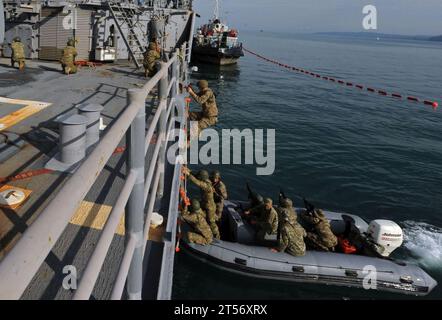 A U.S. Navy boarding team practices tactical movements aboard the USS ...