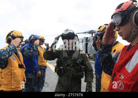 U.S. Navy Rear Adm. John Messerschmidt, front, the director of ...