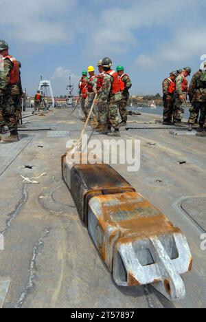 Members of the US Navy Amphibious Construction Battalion 2, off-load a ...