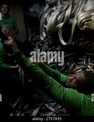US Navy Sailors stow barricades below decks after flight deck drills ...