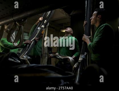 US Navy Sailors stow barricades below decks after flight deck drills ...
