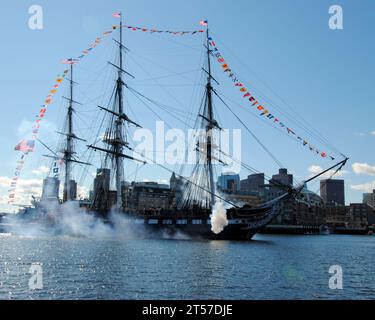 Members of the U.S. Coast Guard salute as the U.S. flag is raised on ...