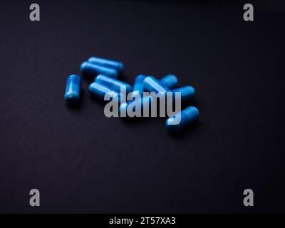 Amino acids capsules on dark paper background. Soft focus Stock Photo ...