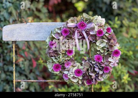 wreath of hydrangea flowers and chrysanthemum hanging on the garden ...