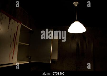 Horror room, kitchen in splashes of blood and hands in a pan on the ...