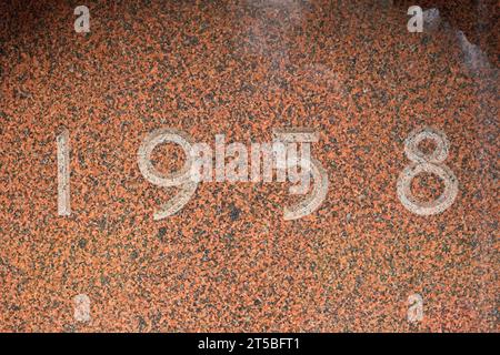 The year 1958 engraved on a gravestone Stock Photo - Alamy