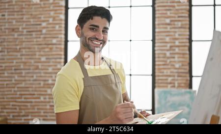 Young hispanic man artist smiling confident drawing at art studio Stock ...
