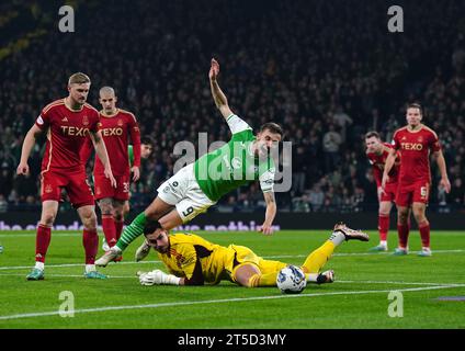 Hibernian's Dylan Vente and Aberdeen goalkeeper Kelle Roos in action ...