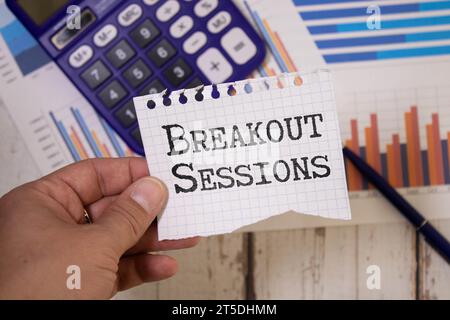 Breakout Session. white torn paper with text on brown background Stock ...