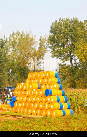 oil drums stacked together in a yard, north china Stock Photo - Alamy