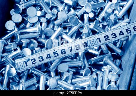new rivet and tape measure piled up together Stock Photo - Alamy