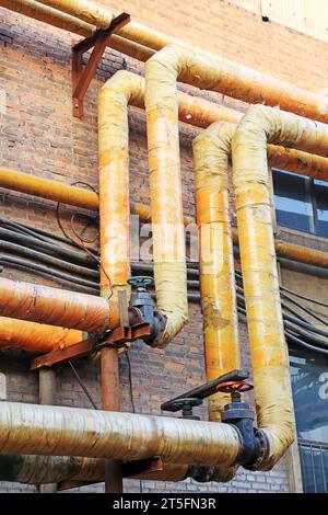 material pipe wrapped in thermal insulation in a factory Stock Photo ...