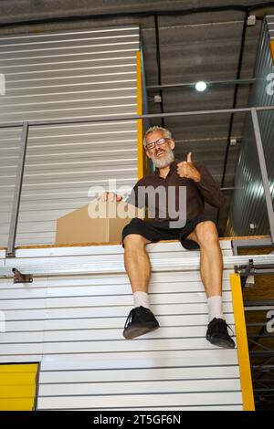 Cheerful bearded long-haired middle-eastern guy with glasses enjoying ...