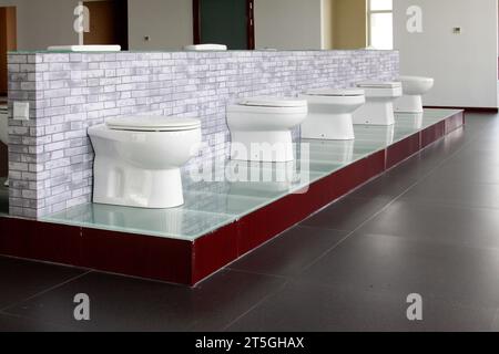 Ceramic toilet display in a hall, closeup of photo Stock Photo - Alamy
