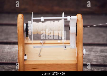 The spinning equipment includes a wooden spindle and a hand tool for ...