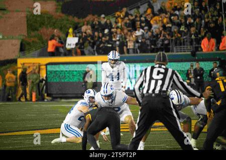 BYU kicker Will Ferrin (44), with punter Sam Vander Haar holding, kicks ...