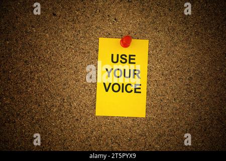 Yellow note paper with word election on cork board background with copy ...