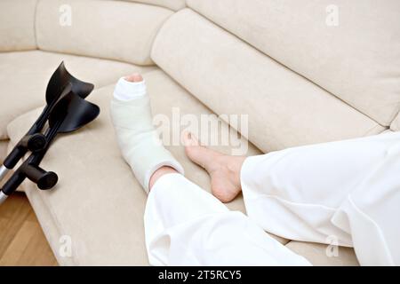 Foot with broken toe bone in orange fiberglass cast pink background ...