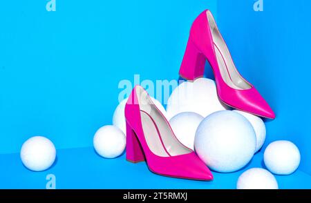 Glamourous red high heels with pointed toe placed in the corner of blue ...