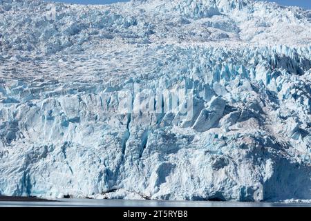 Blue ice of the Aialik Glacier meets the ocean waters of the Gulf of ...