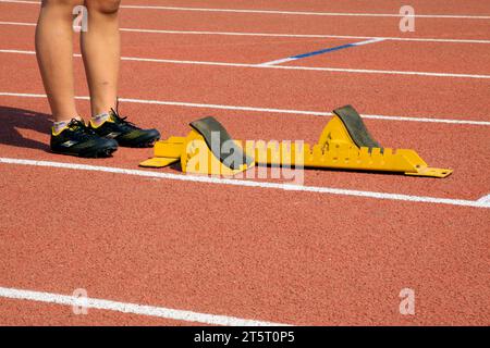 Starting blocks and the athlete's leg, closeup of photo Stock Photo - Alamy