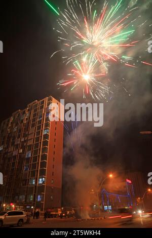 Fireworks over buildings Stock Photo - Alamy