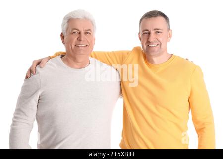 Mature brothers hugging on white background Stock Photo - Alamy