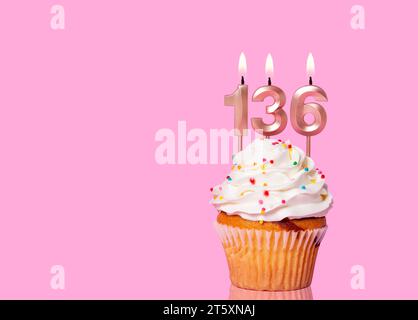 Candle number 136 - cupcake birthday in rhodamine red background Stock ...