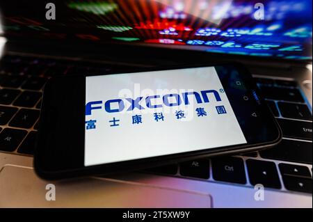 In this photo illustration, a Foxconn logo seen displayed on a ...