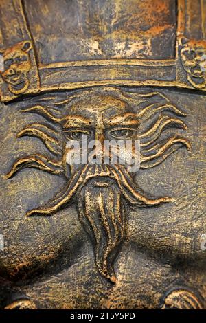 Character faces on copper metal plates Stock Photo - Alamy